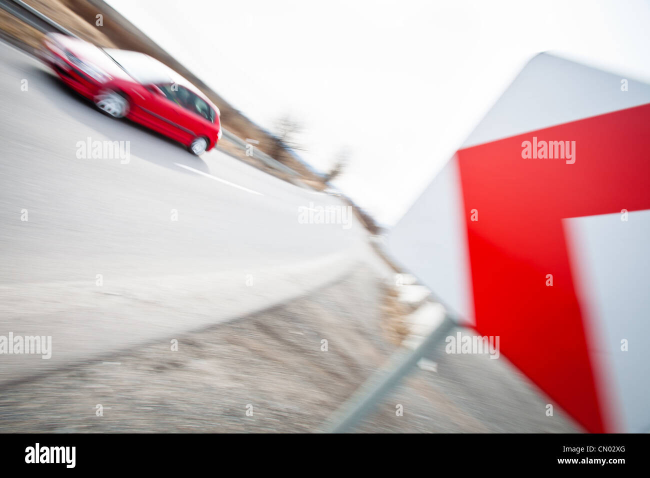 Traffic concept: car driving fast through a sharp turn (motion blur is ...