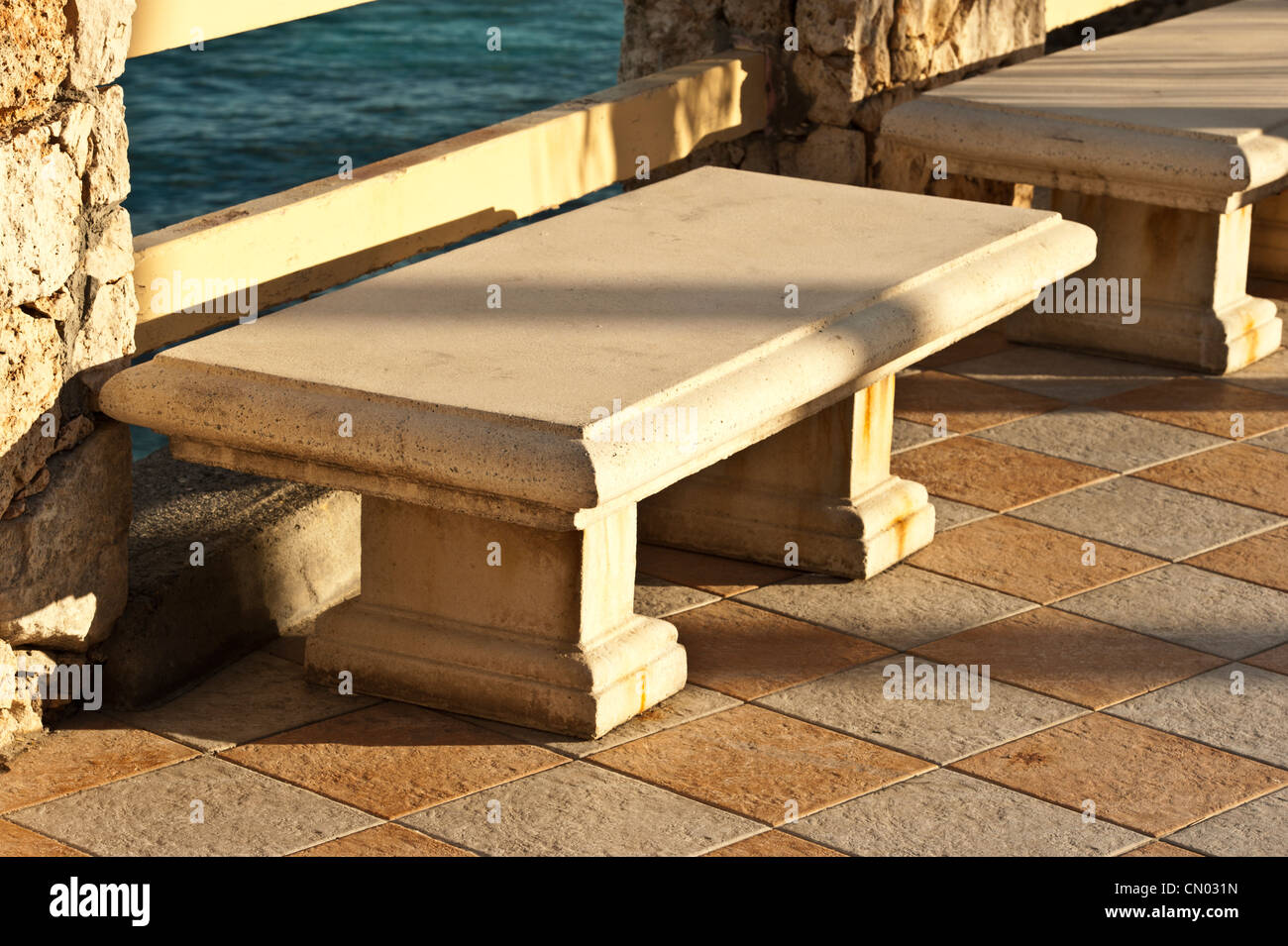 Stone benches lined along a sidewalk Stock Photo - Alamy