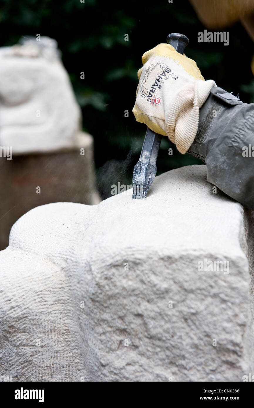 A magnificent closeup of an artist chiseling a sculpture outdoors Stock ...