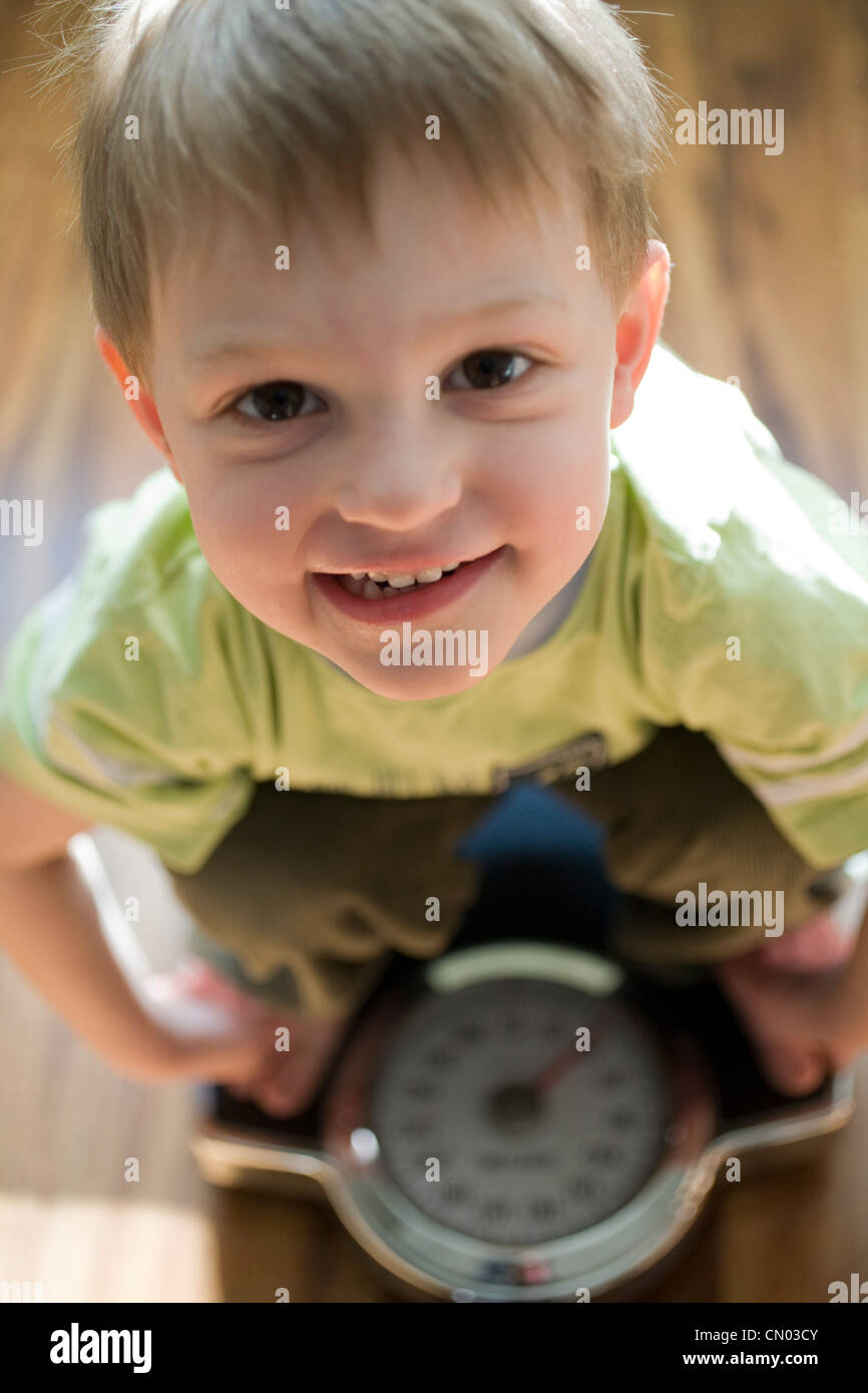 Boy Standing on Scale Stock Photo - Alamy