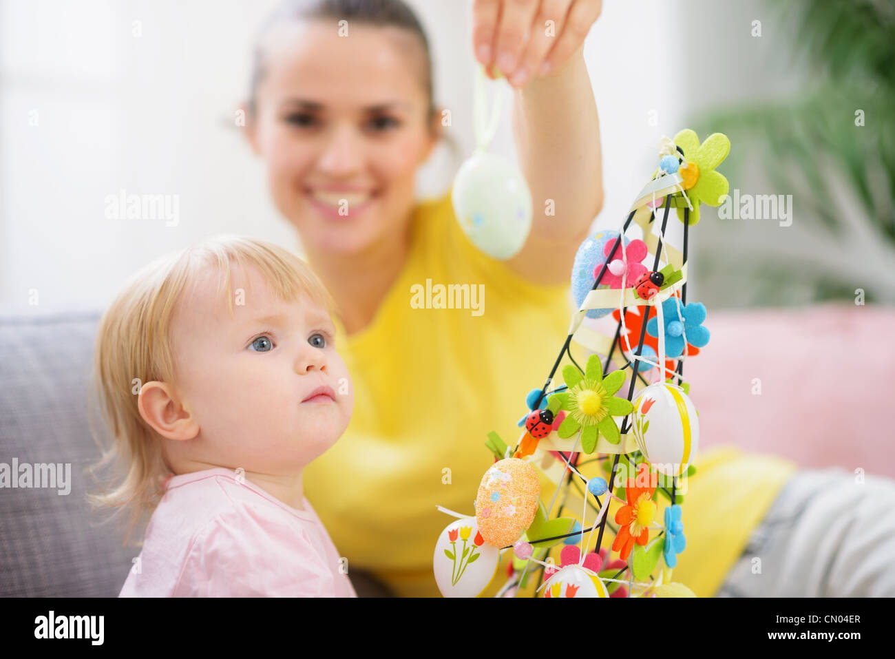 Mother showing baby Easter egg Stock Photo - Alamy