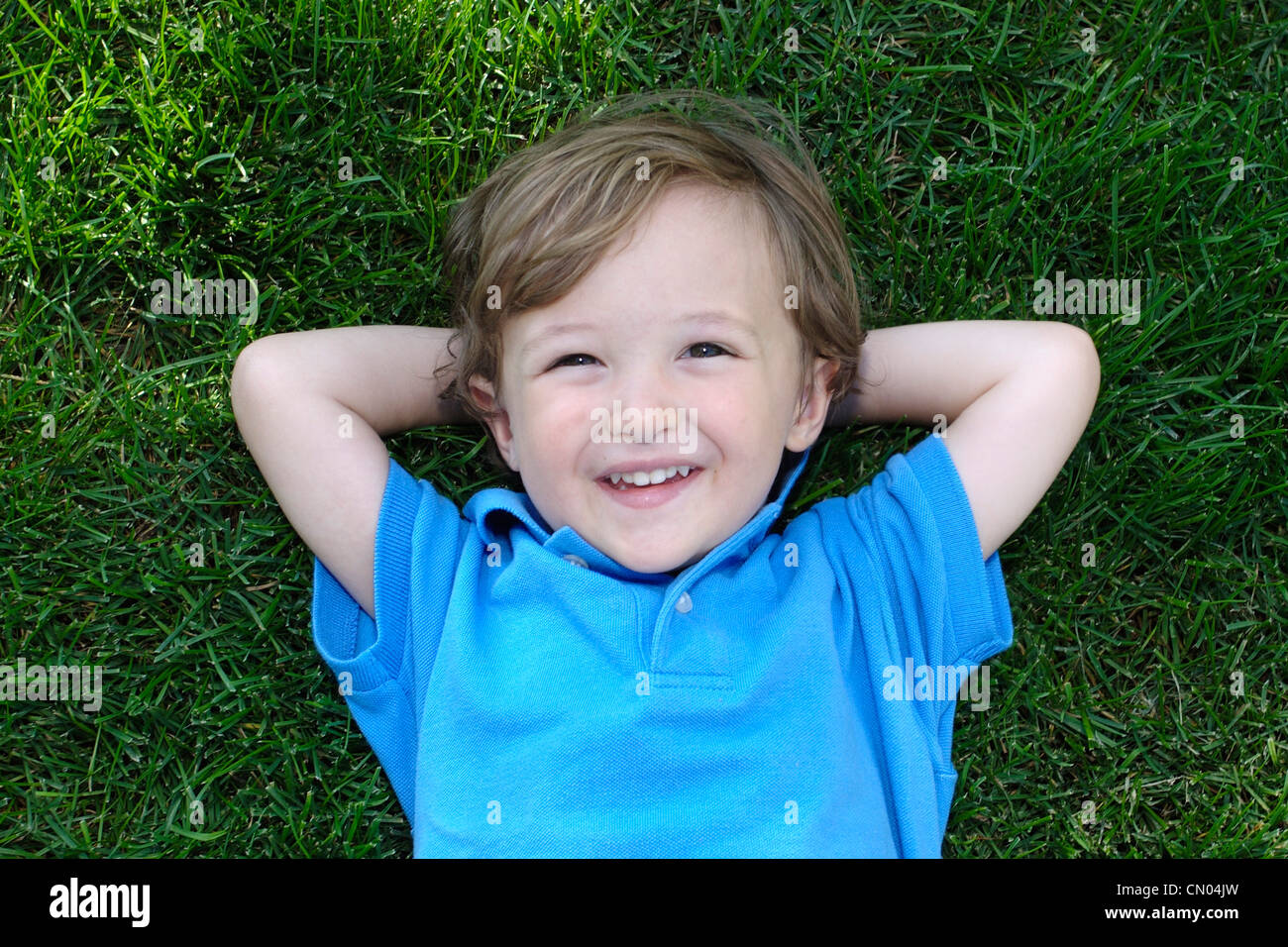 Boy Laying on Grass, Toronto, Ontario Stock Photo - Alamy