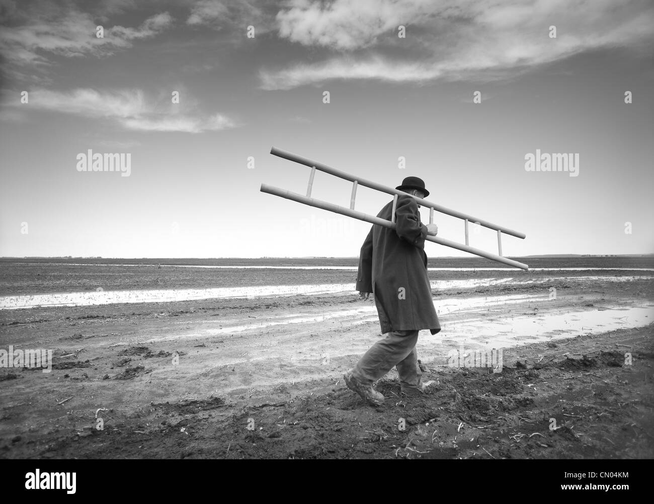 Man carrying ladder Black and White Stock Photos & Images - Alamy