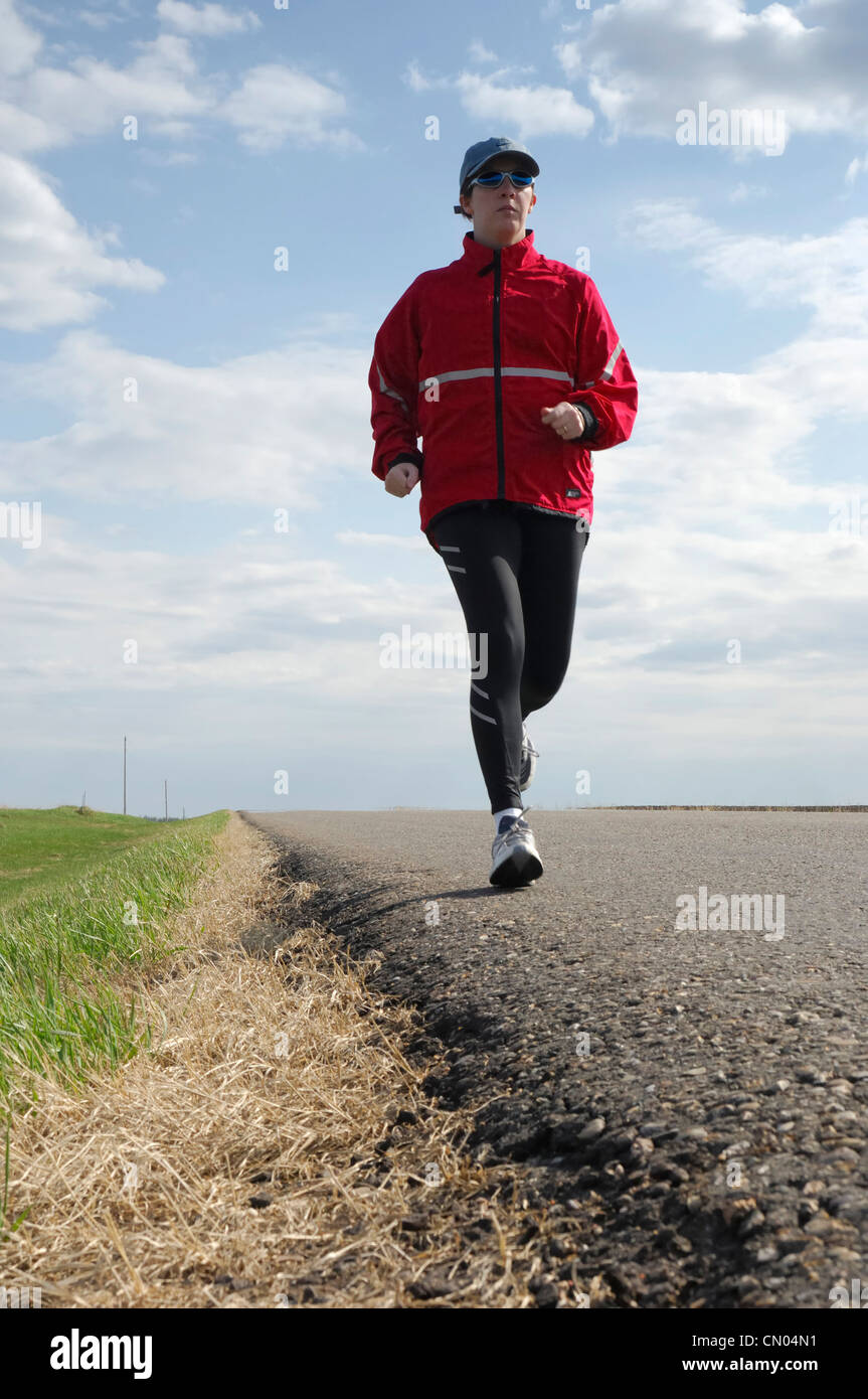 Woman Running along Country Road, Strathcona County, Alberta Stock ...
