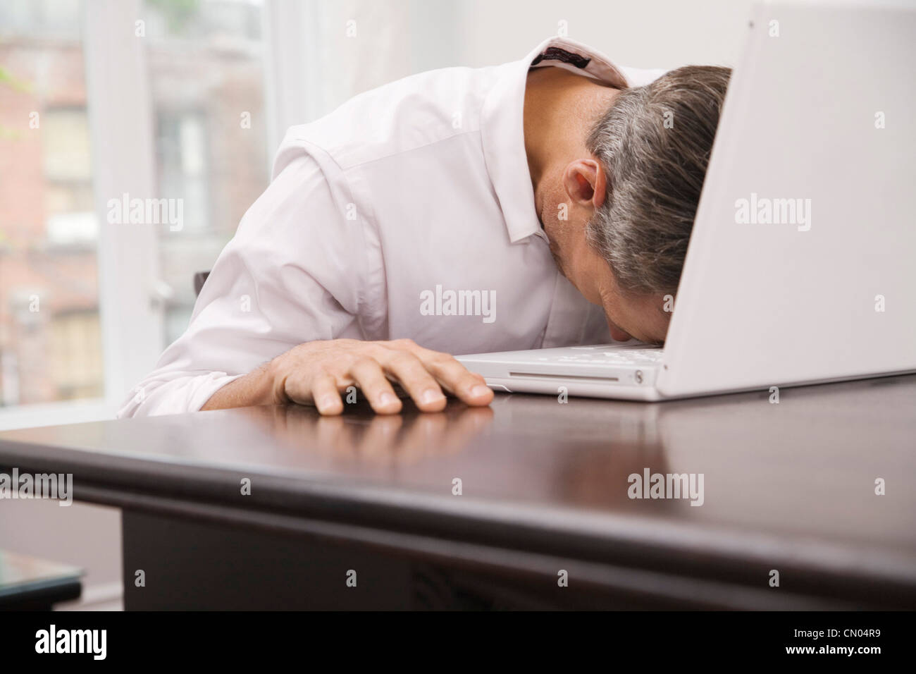 Man with Head on Laptop, Toronto, Ontario Stock Photo - Alamy