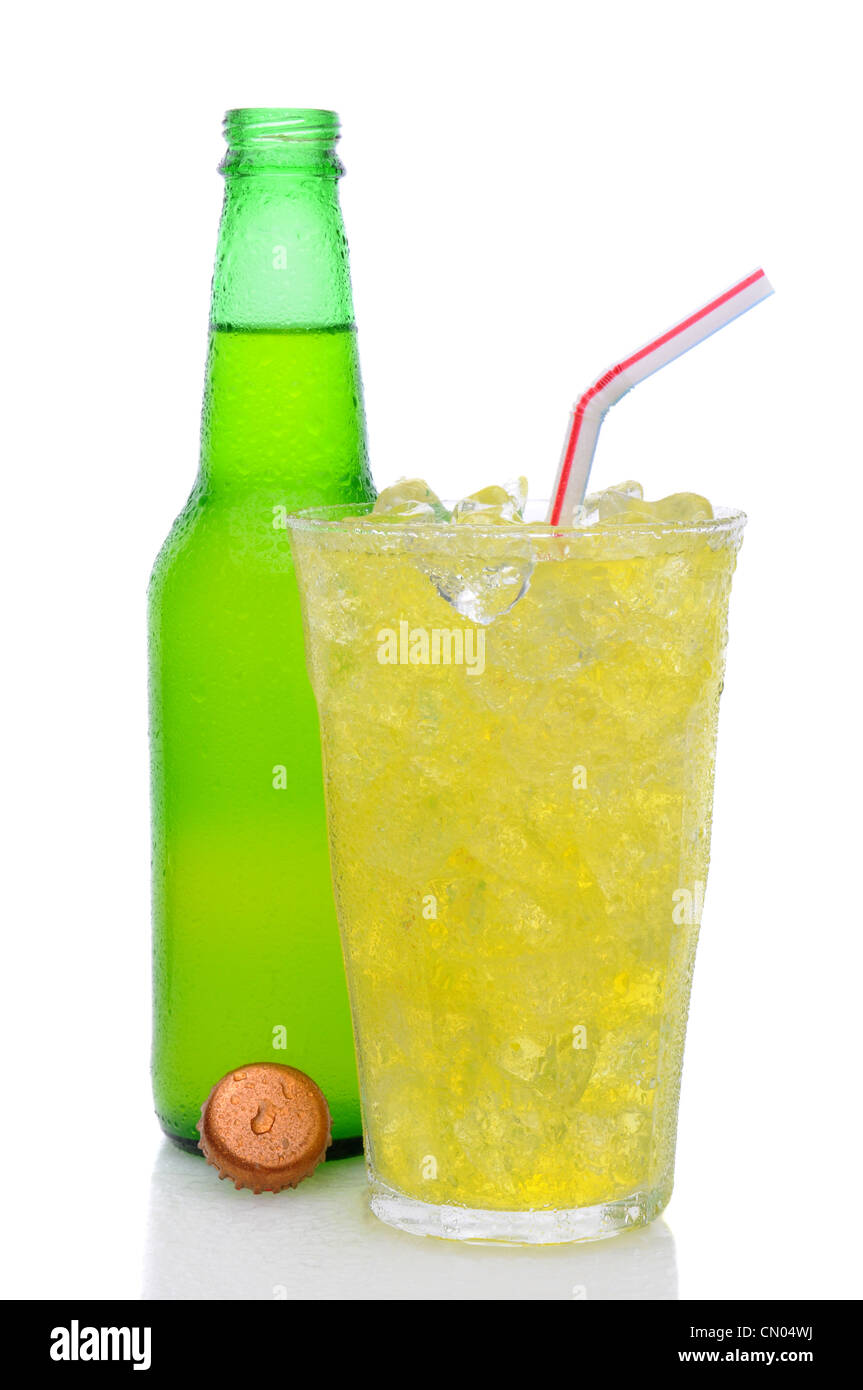 A bottle of Lemon Lime soda with cap off standing behind a glass filled ...