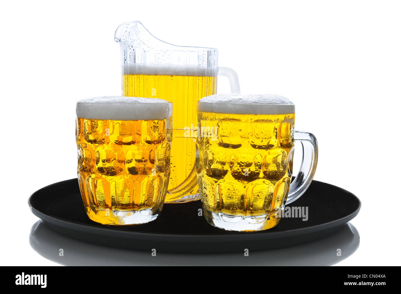 A pitcher of beer and two full glasses on a serving tray over a white ...