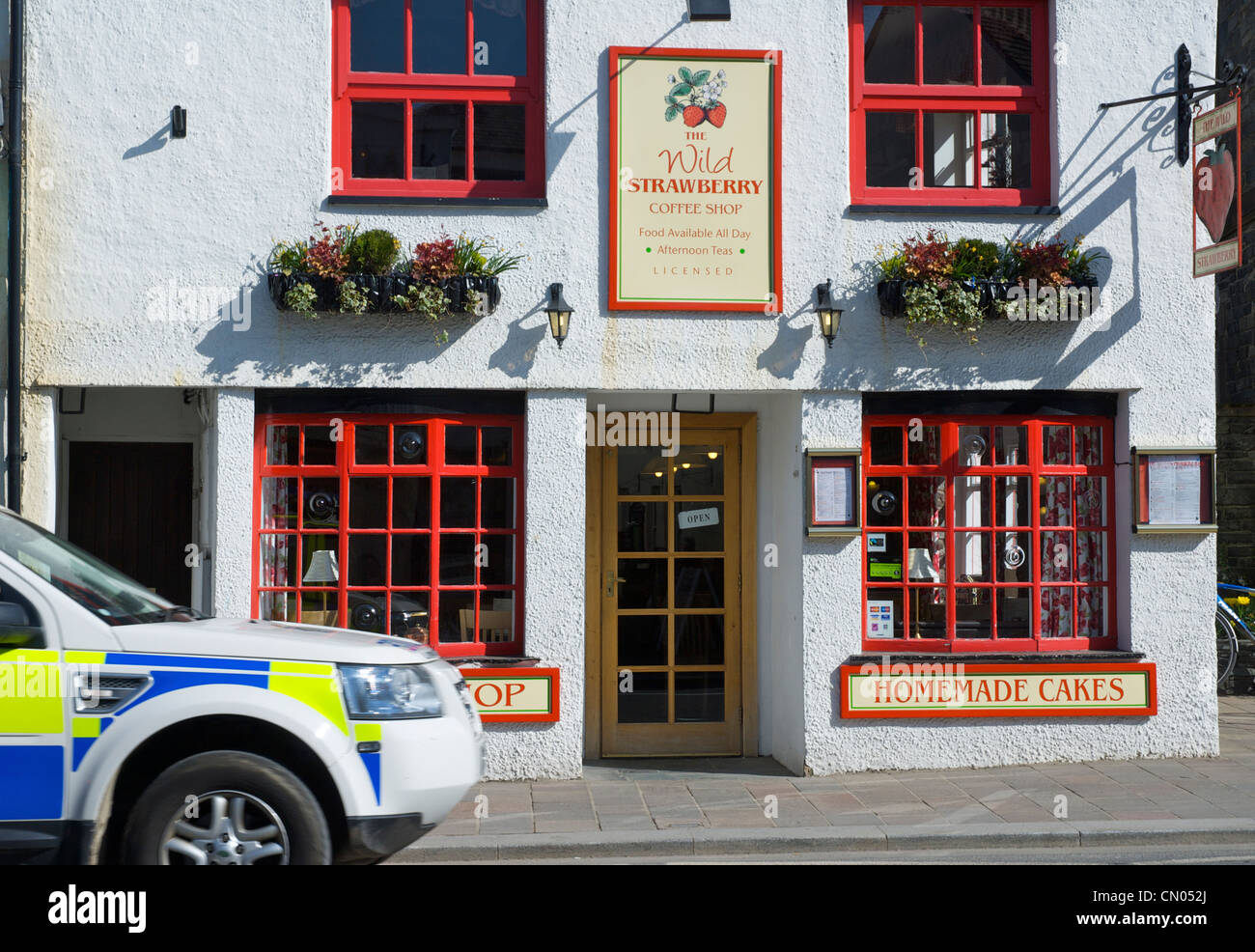 Police car passing the Wild Strawberry Coffee Shop, Keswick, Lake ...