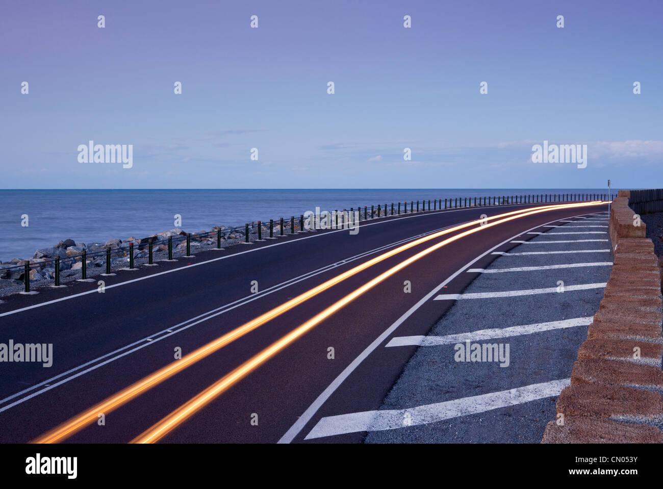 Car light trails on coastal highway. Captain Cook Highway between Port ...