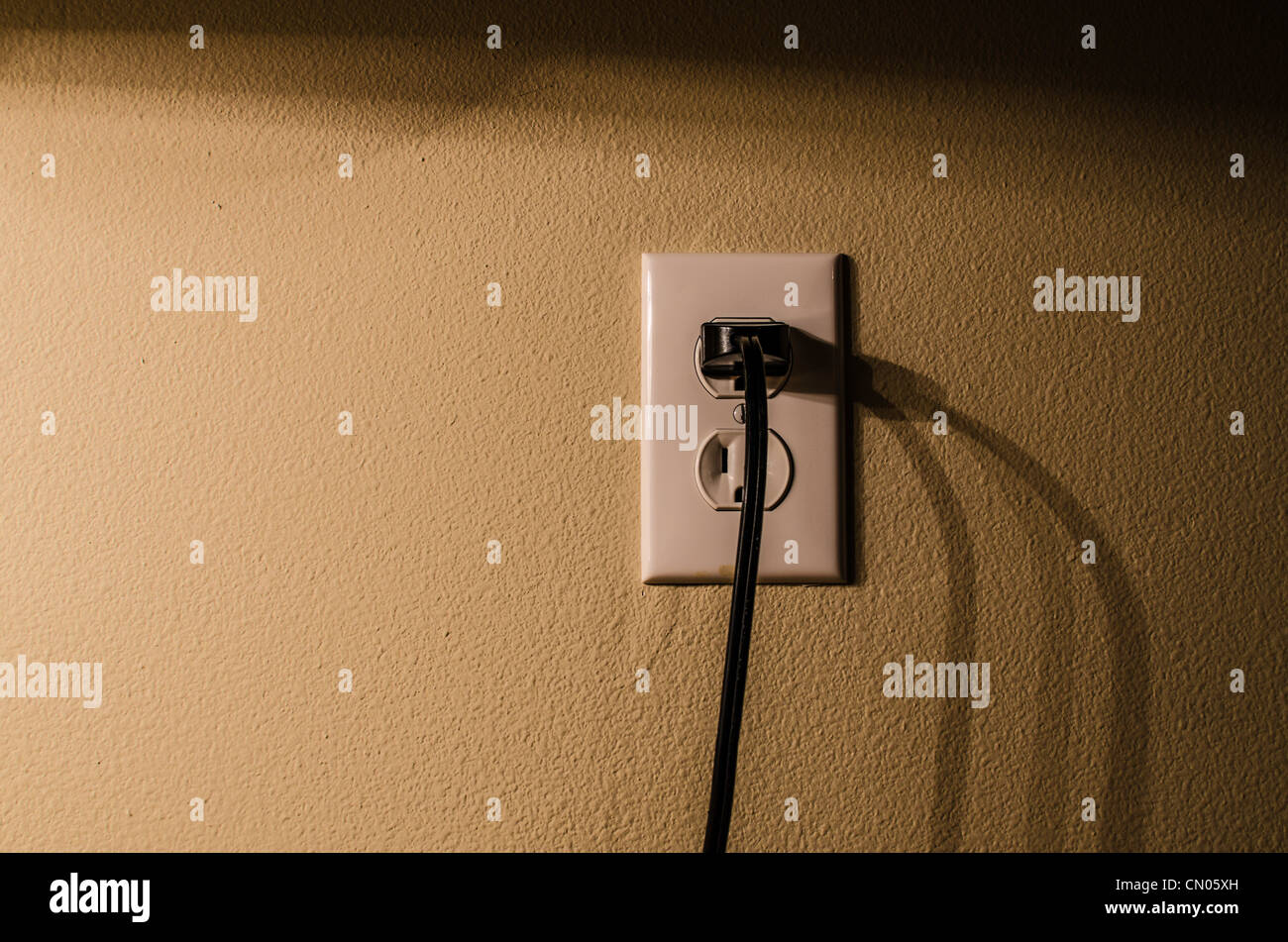 Plug in a plug outlet Stock Photo - Alamy