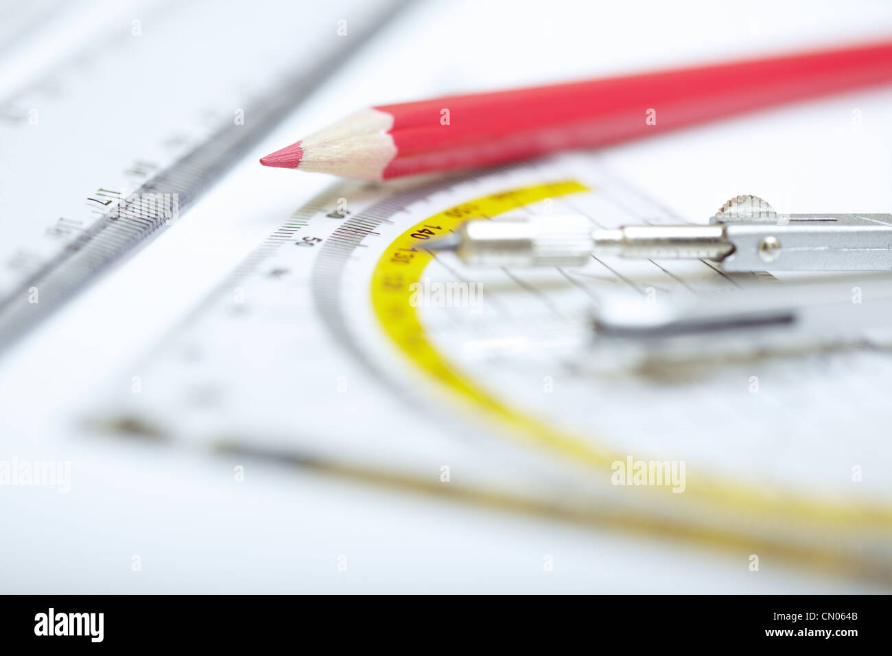 Red pencil with compasses and rulers on a paper. Extremely close-up ...