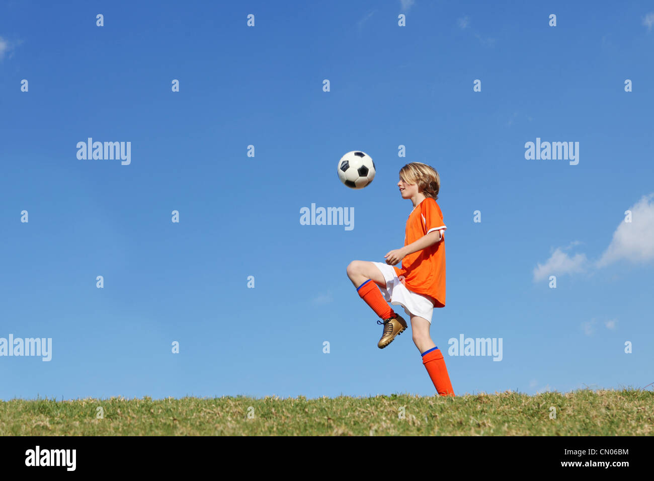 boy kid playing soccer kicking football Stock Photo - Alamy