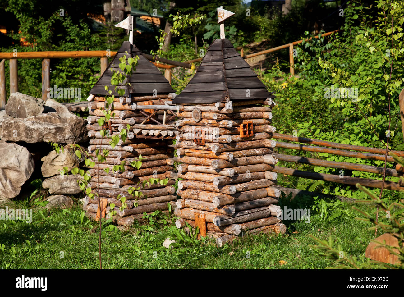 Miniature wooden towers in forest in summer Stock Photo - Alamy