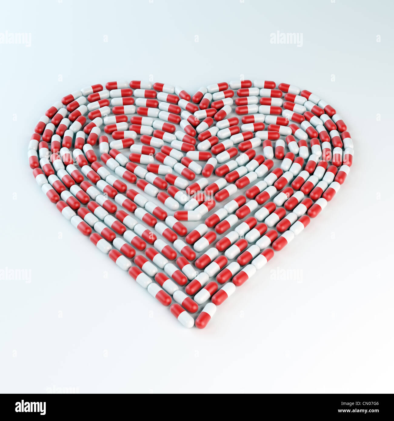 Red and white capsules forming a heart shape - cardiology concept Stock ...