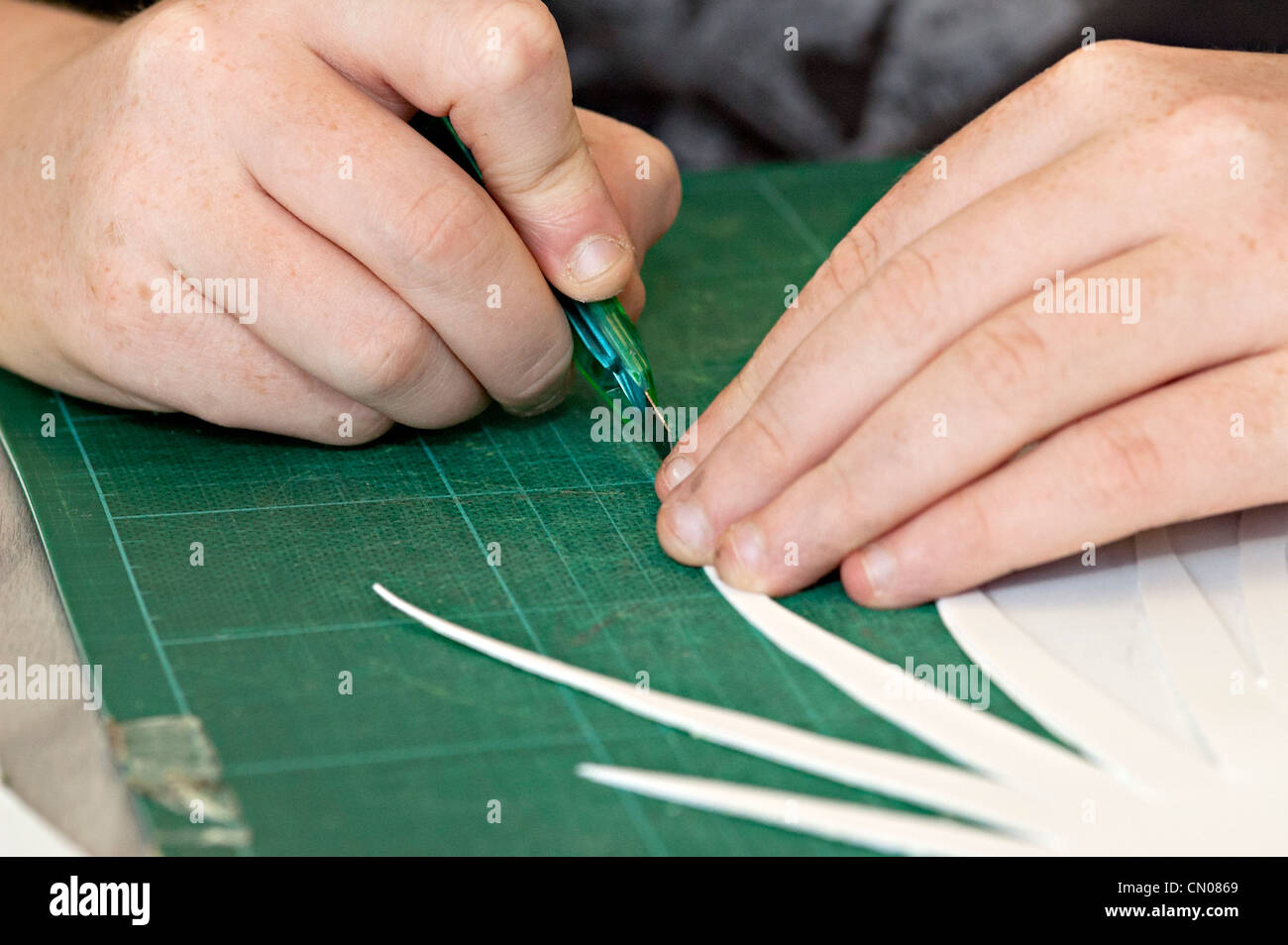 hands cutting out a shape in card for art pieces Stock Photo - Alamy