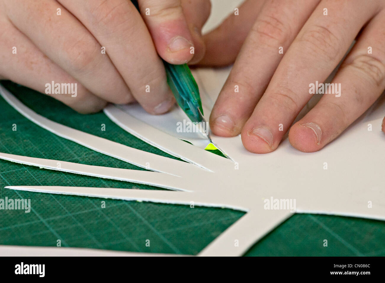 hands cutting out a shape in card for art pieces Stock Photo - Alamy