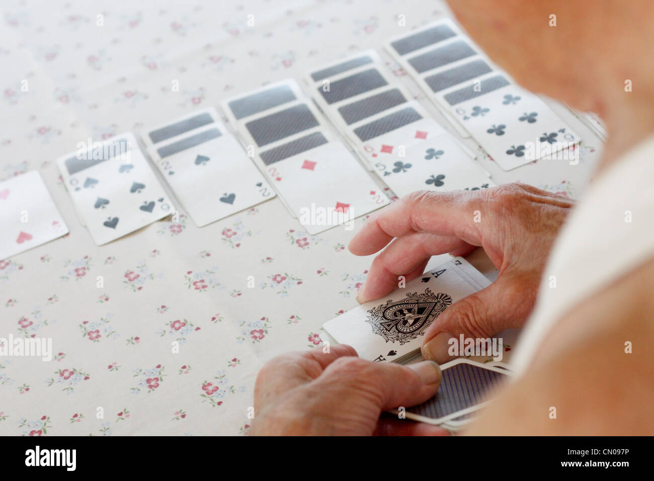 Senior playing solitaire Stock Photo - Alamy