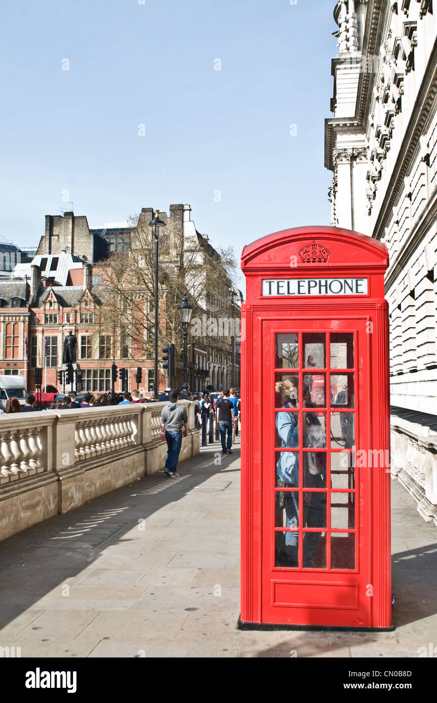 A young person in a London telephone box Stock Photo - Alamy