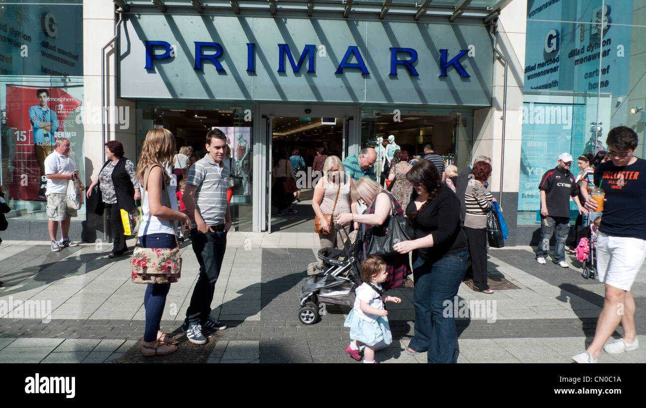 Shoppers outside Primark storefront store on Queen Street Cardiff Wales ...