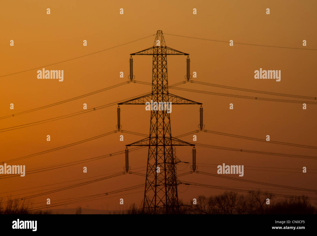 Energy Distribution Network - Electricity Pylons against Orange and ...