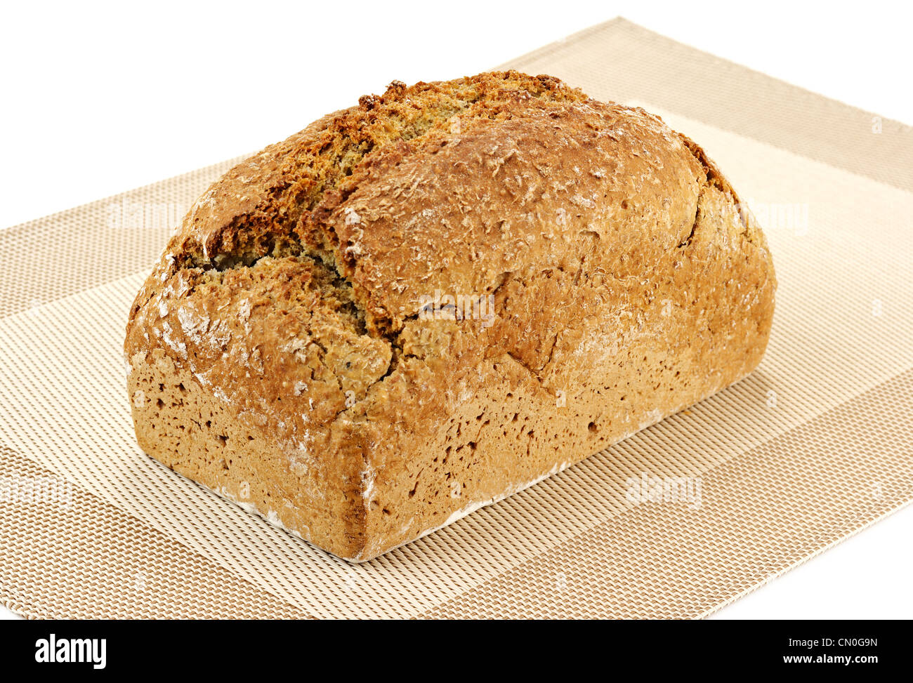 a loaf of bread on a textured tray on a white table Stock Photo - Alamy