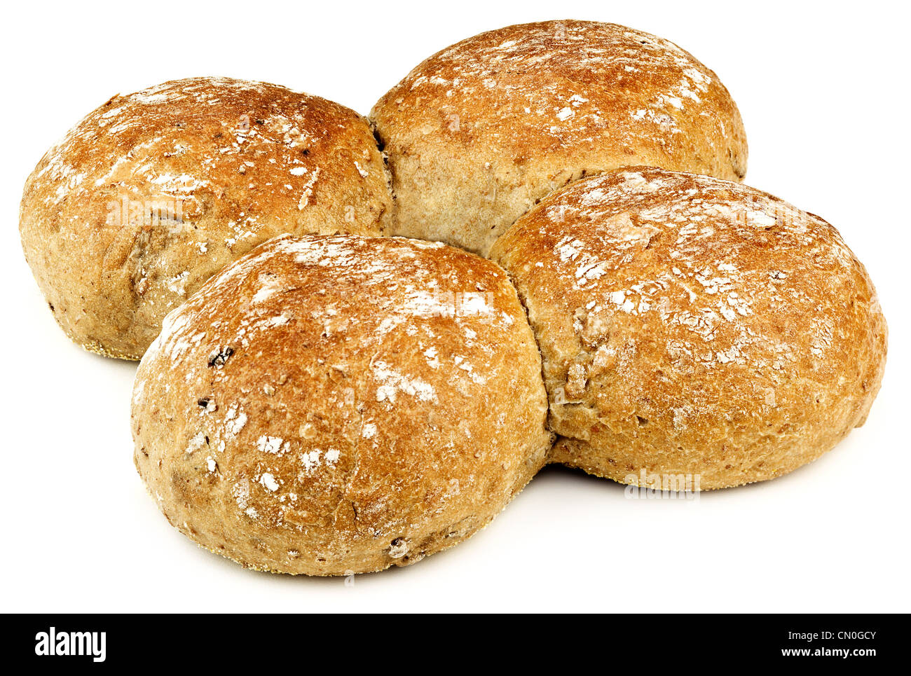 four buns with a bit of flour on them placed on a white table Stock ...