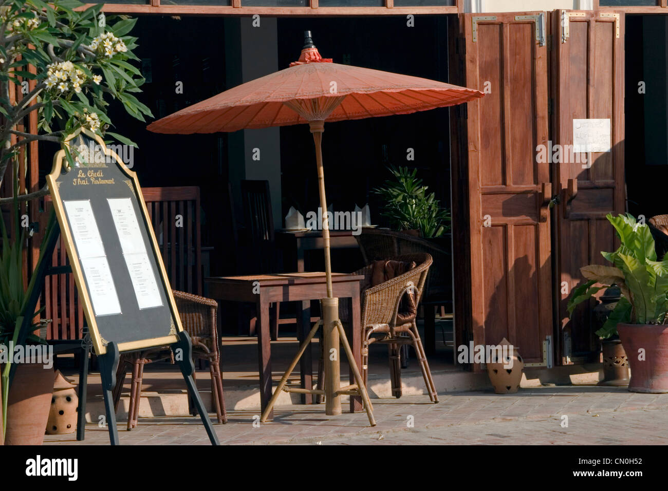 Le Chedi Thai Restaurant. a sidewalk restaurant with umbrellas, is a ...