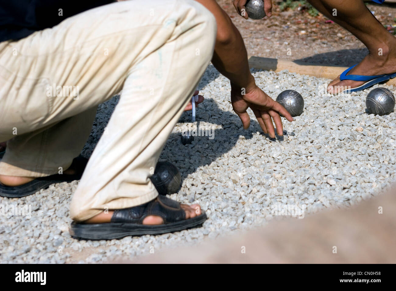 A group of men are playing bocci ball in Luang Prabang, Laos. Luang ...