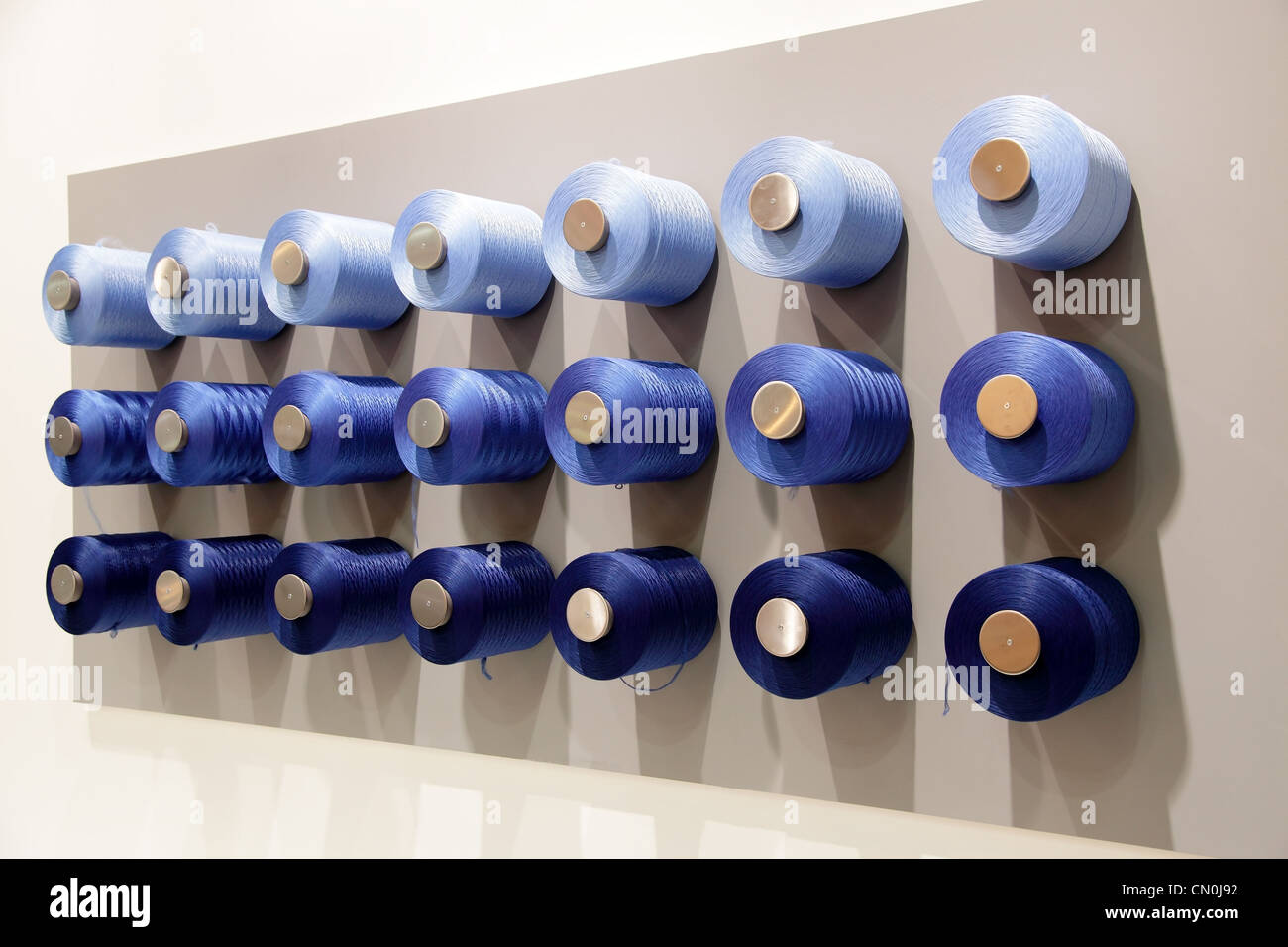 Spools with threads hanging on the wall Stock Photo - Alamy