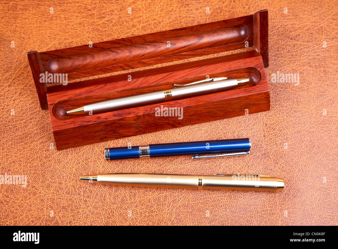 Three pens on a textural background Stock Photo - Alamy