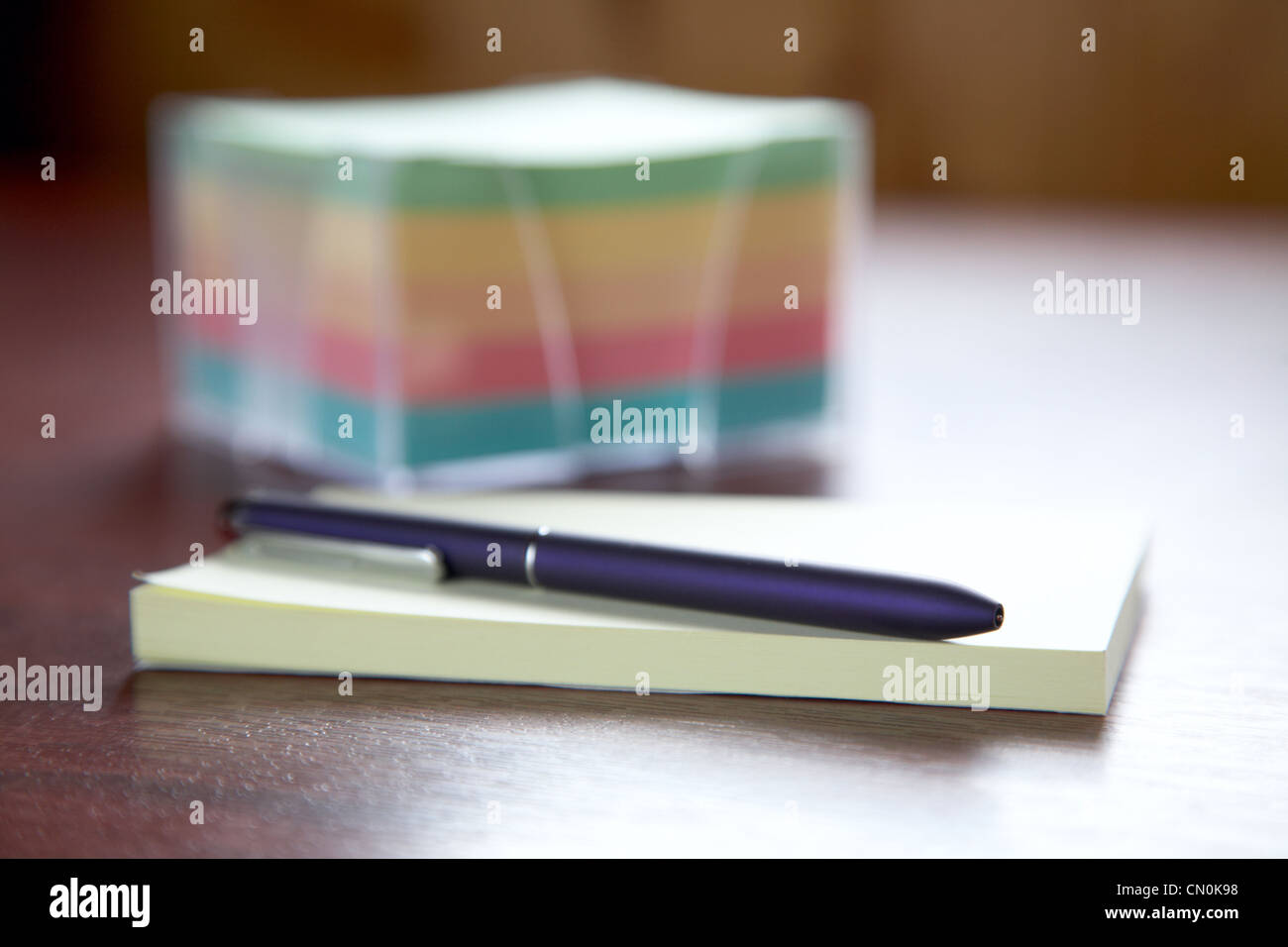 Pile of sticky note and pen on a desk Stock Photo - Alamy