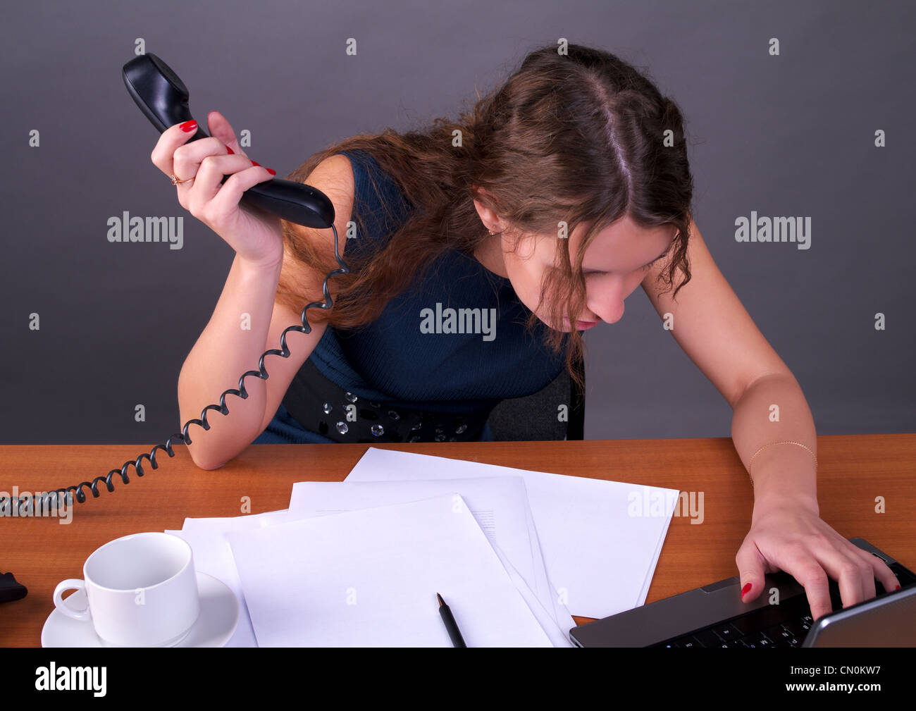 Cute young business woman working hard Stock Photo - Alamy