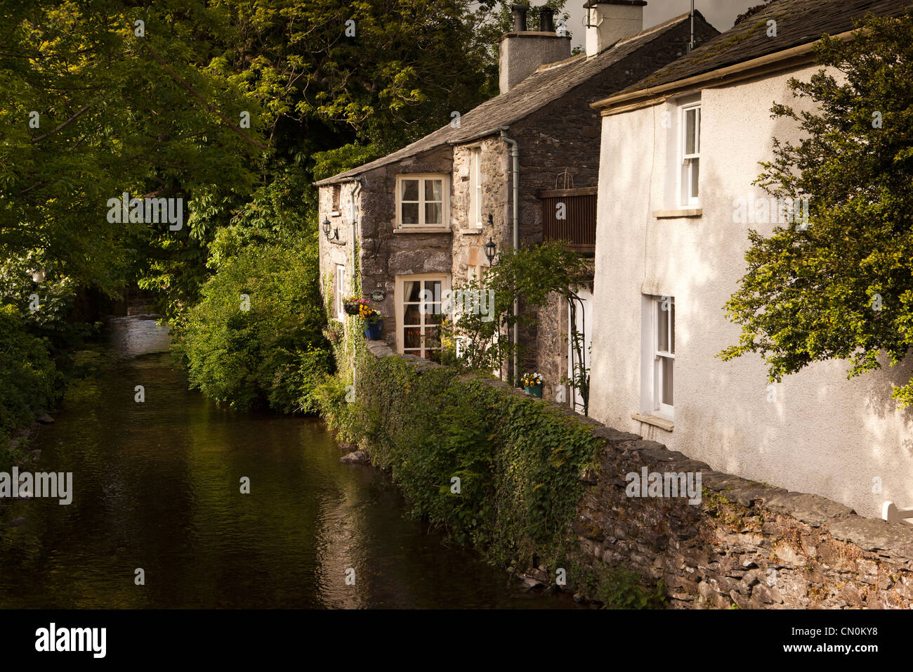 UK, Cumbria, Cartmel house beside River Eea flowing through the village ...