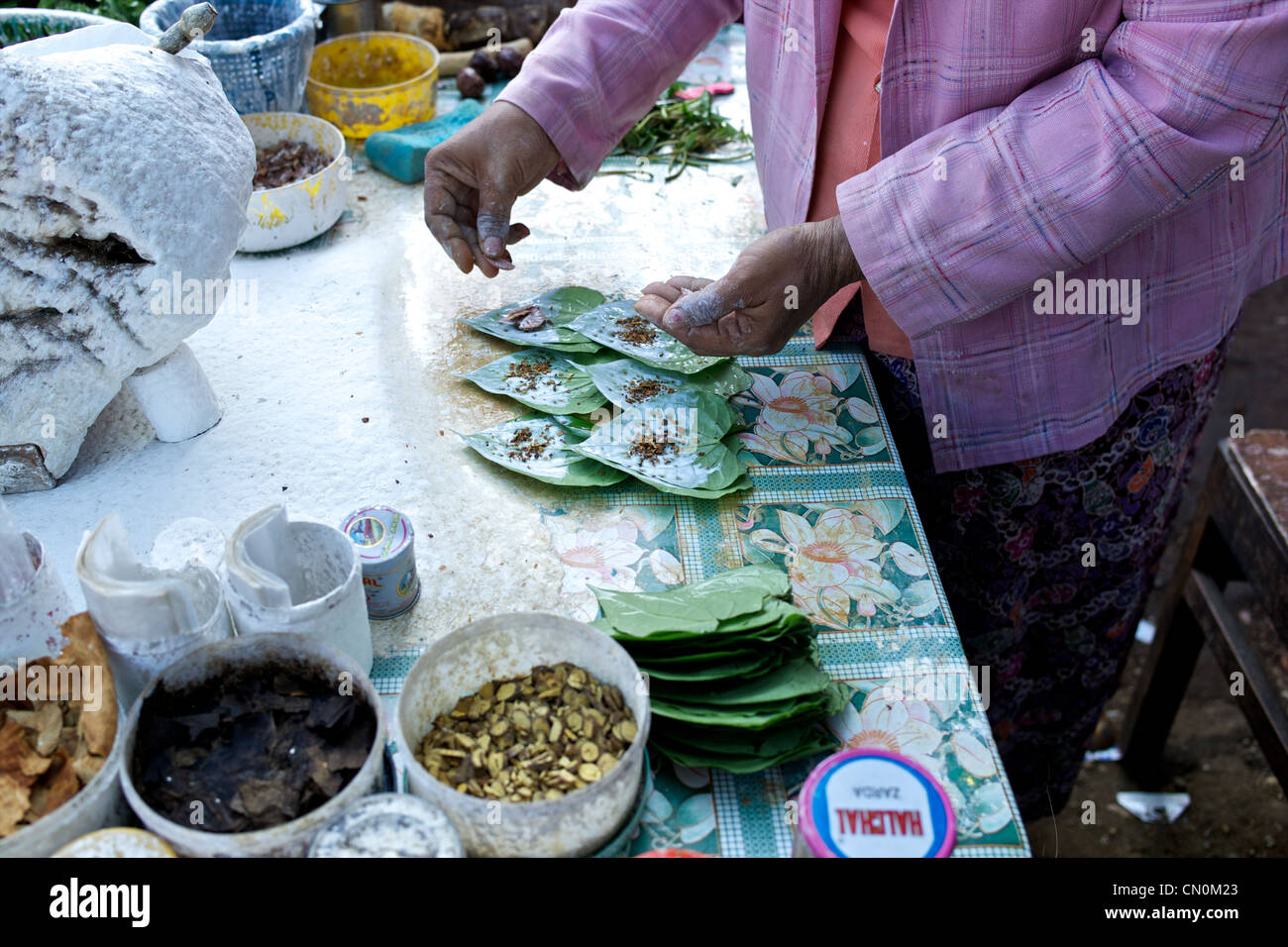 Burmese woman prepares betel leaf chews on the streets of Yangon ...