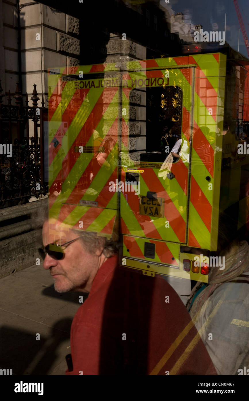 Reflections of londoners and the reflected rear of an NHS London ...