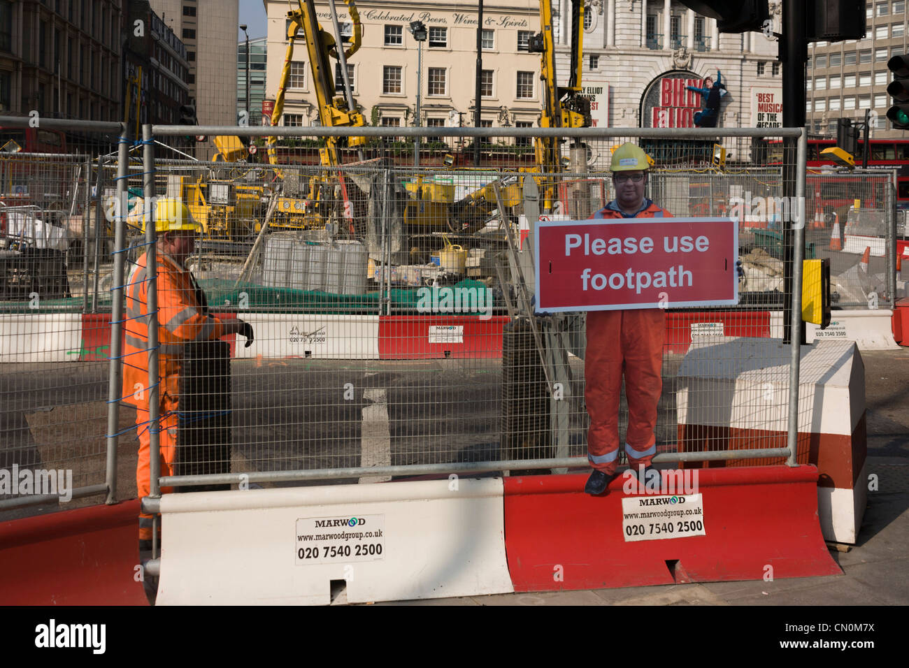 Real passing construction worker and a scaled human workman figure who ...