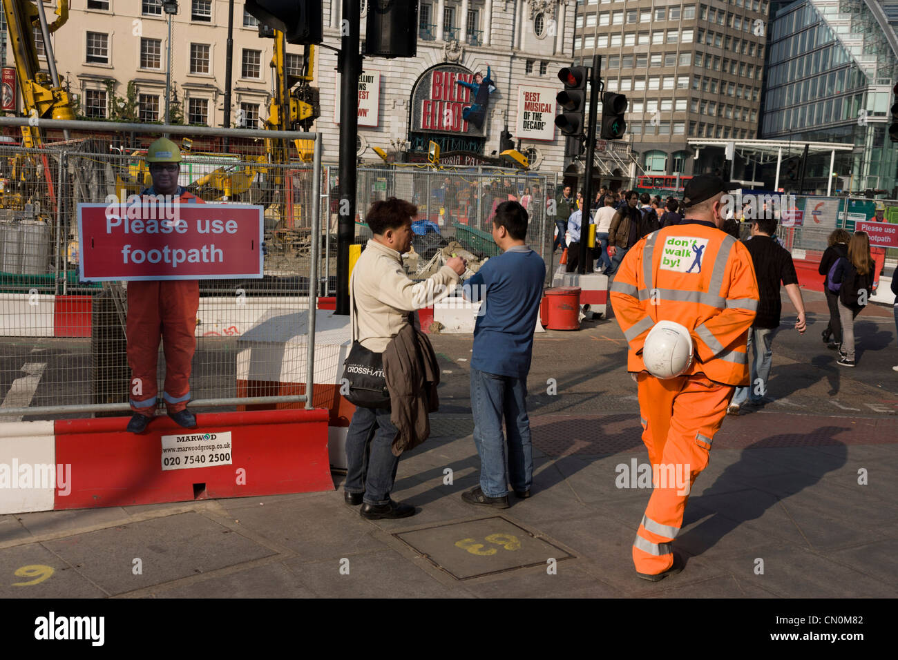 Real passing construction worker and a scaled human workman figure who ...