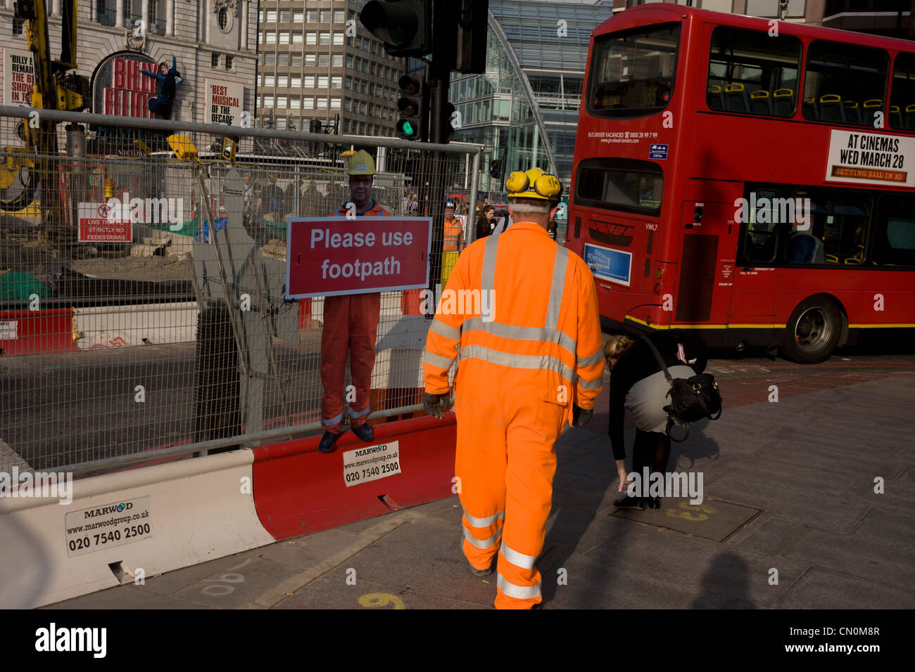 Real passing construction worker and a scaled human workman figure who ...