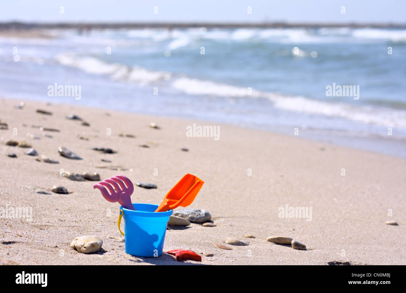 Plastic bucket on the beach near the sea Stock Photo - Alamy