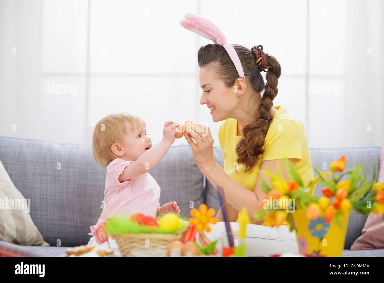 Mother and baby knocking Easter eggs Stock Photo - Alamy