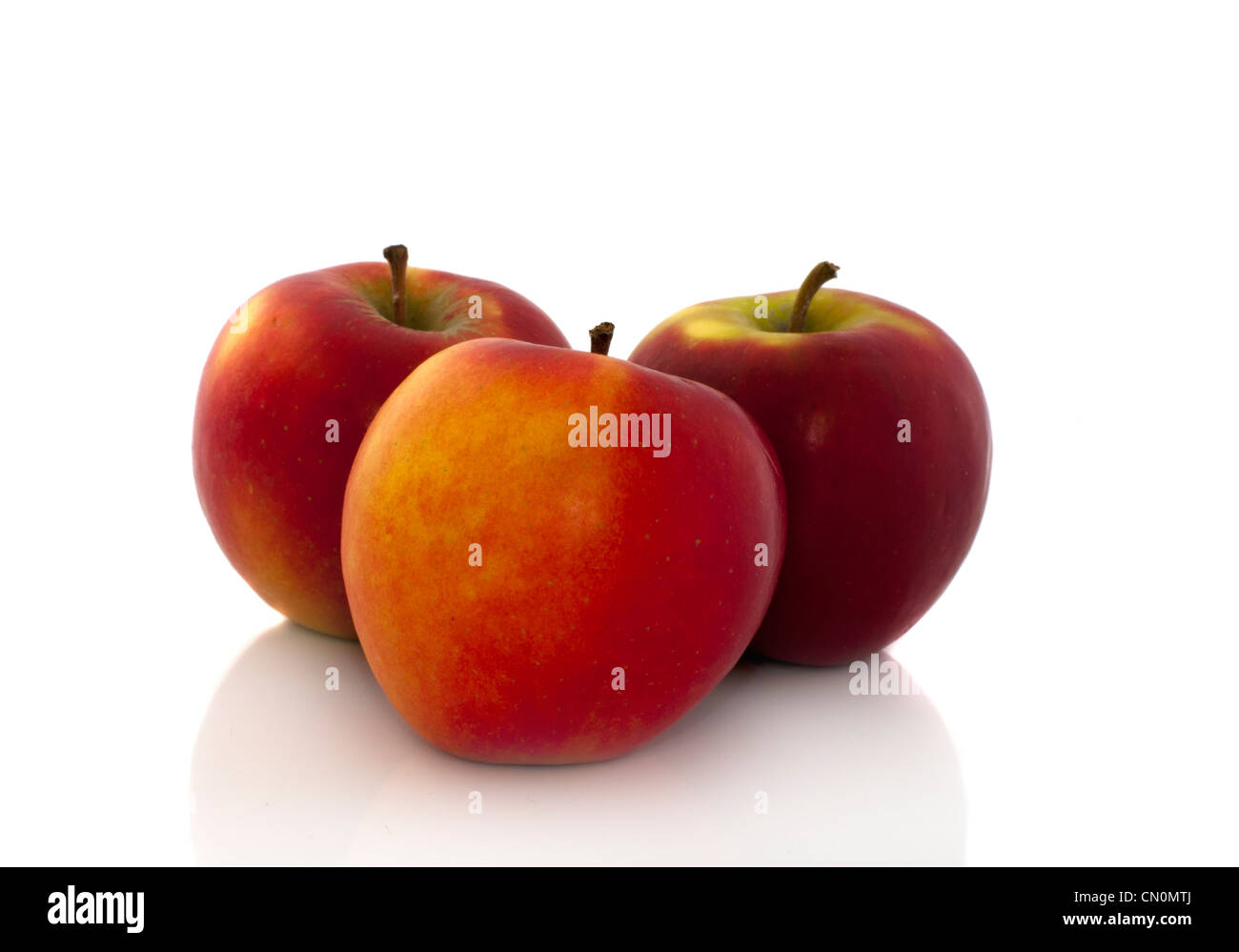 three red appels islated on white Stock Photo - Alamy