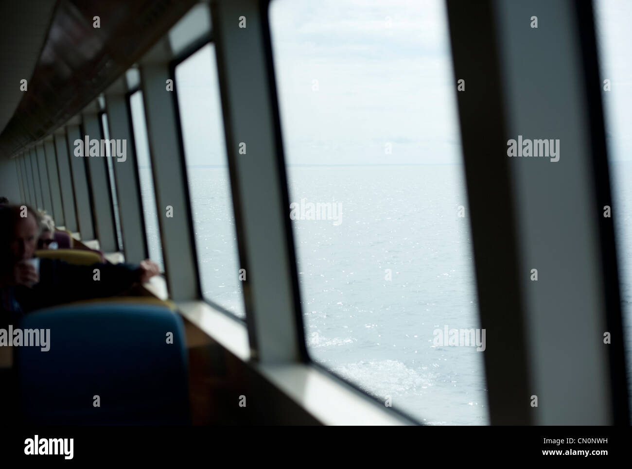 The windows looking to the sea from inside a passenger ferry sailing to ...