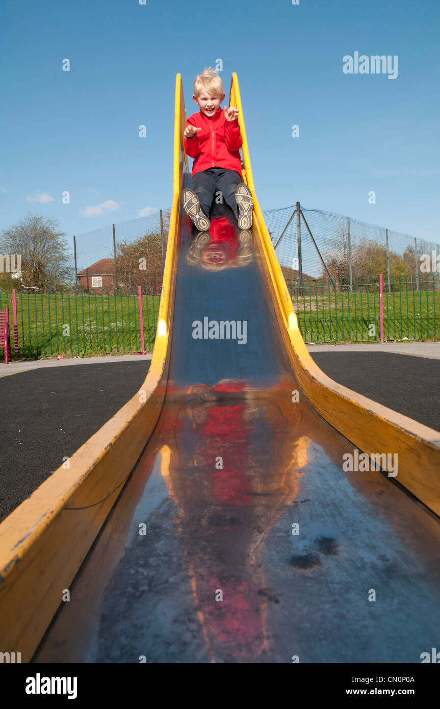 Boy on slide (part of sequence of 10 Stock Photo - Alamy
