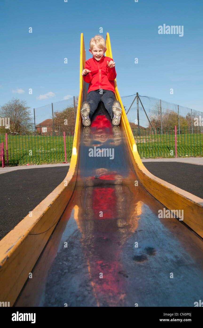 Boy on slide (part of sequence of 10 Stock Photo - Alamy