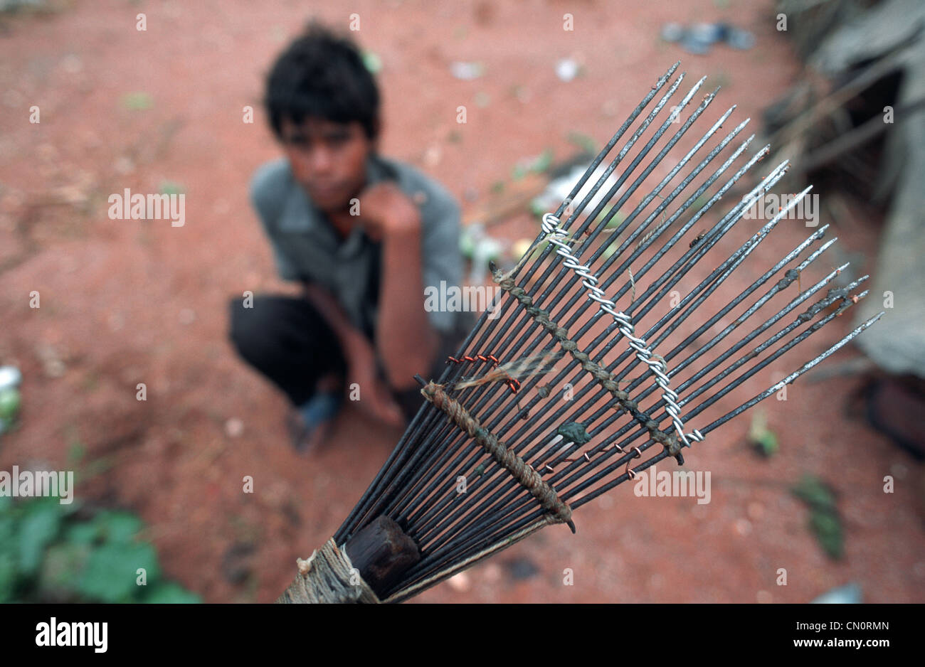 Harpoon used to fish. In the background, a boy belonging to a fishermen ...