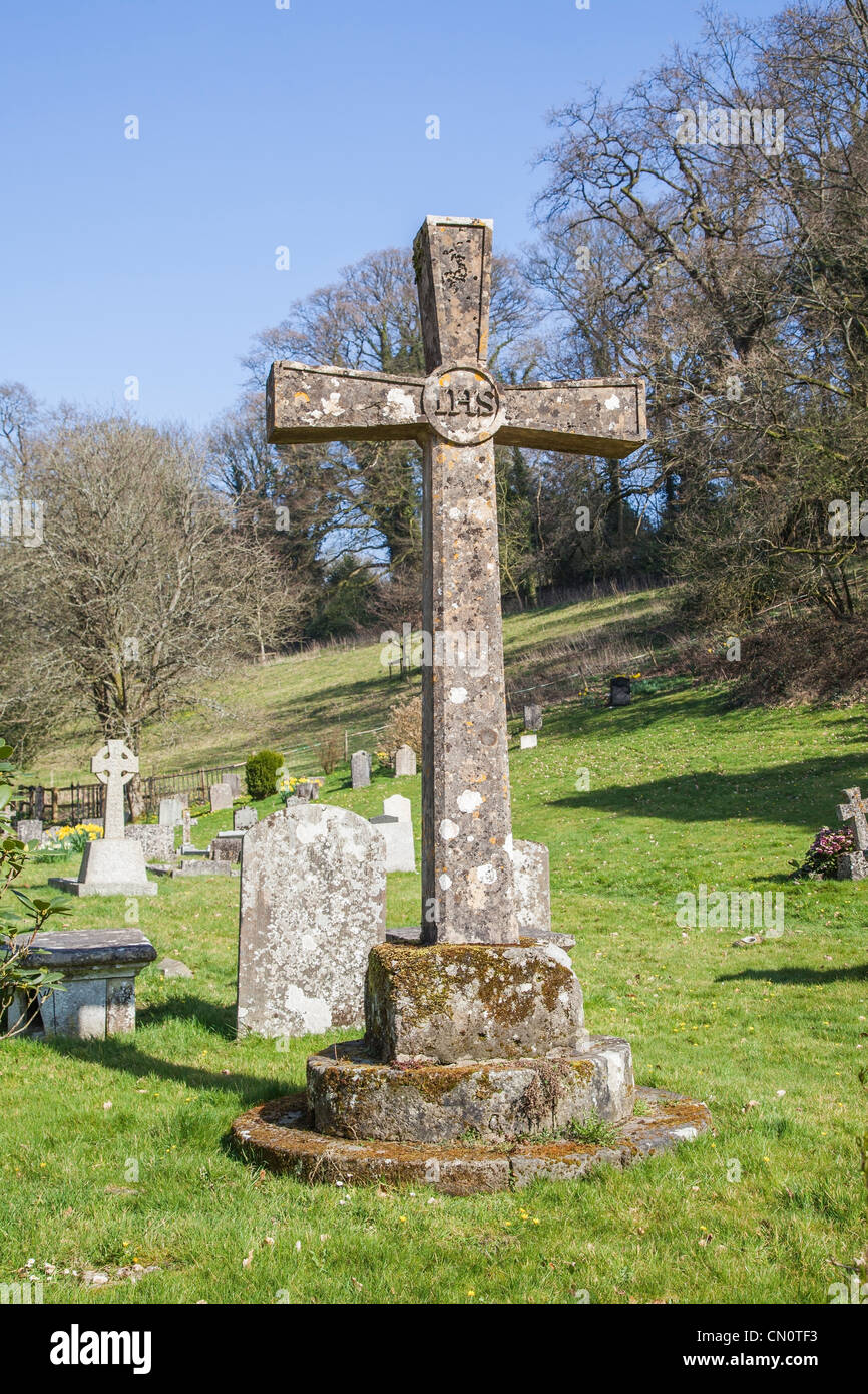 Traditional stone cross in the churchyard of St Peter's Church ...