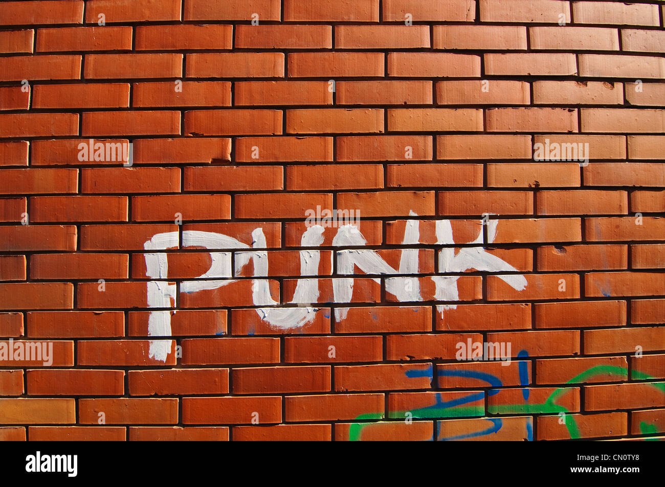 Work punk written on a red brick wall Stock Photo - Alamy
