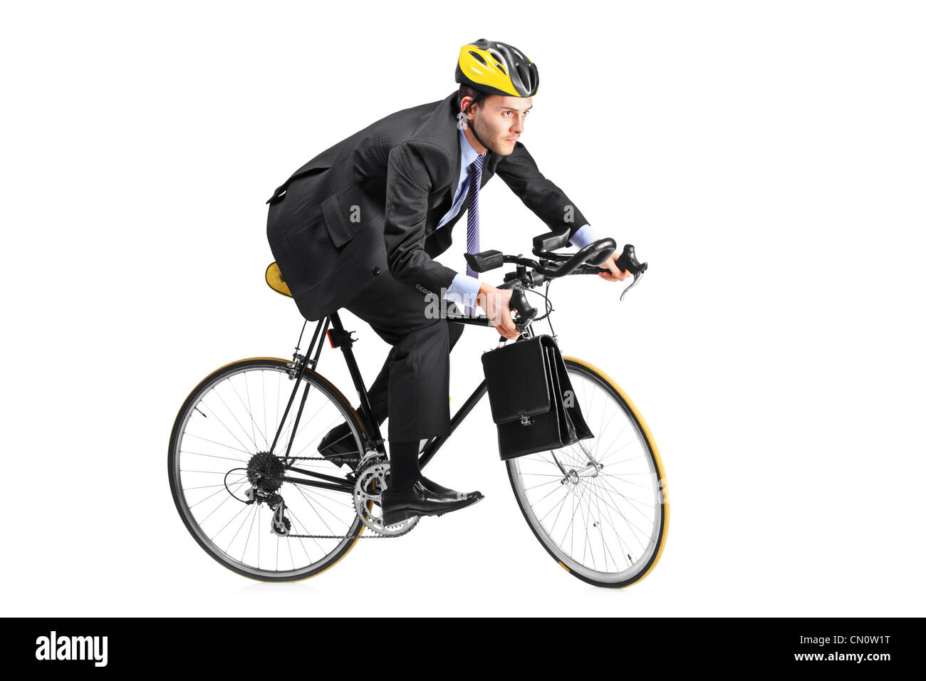 A young businessman riding a bicycle going towards his workplace ...