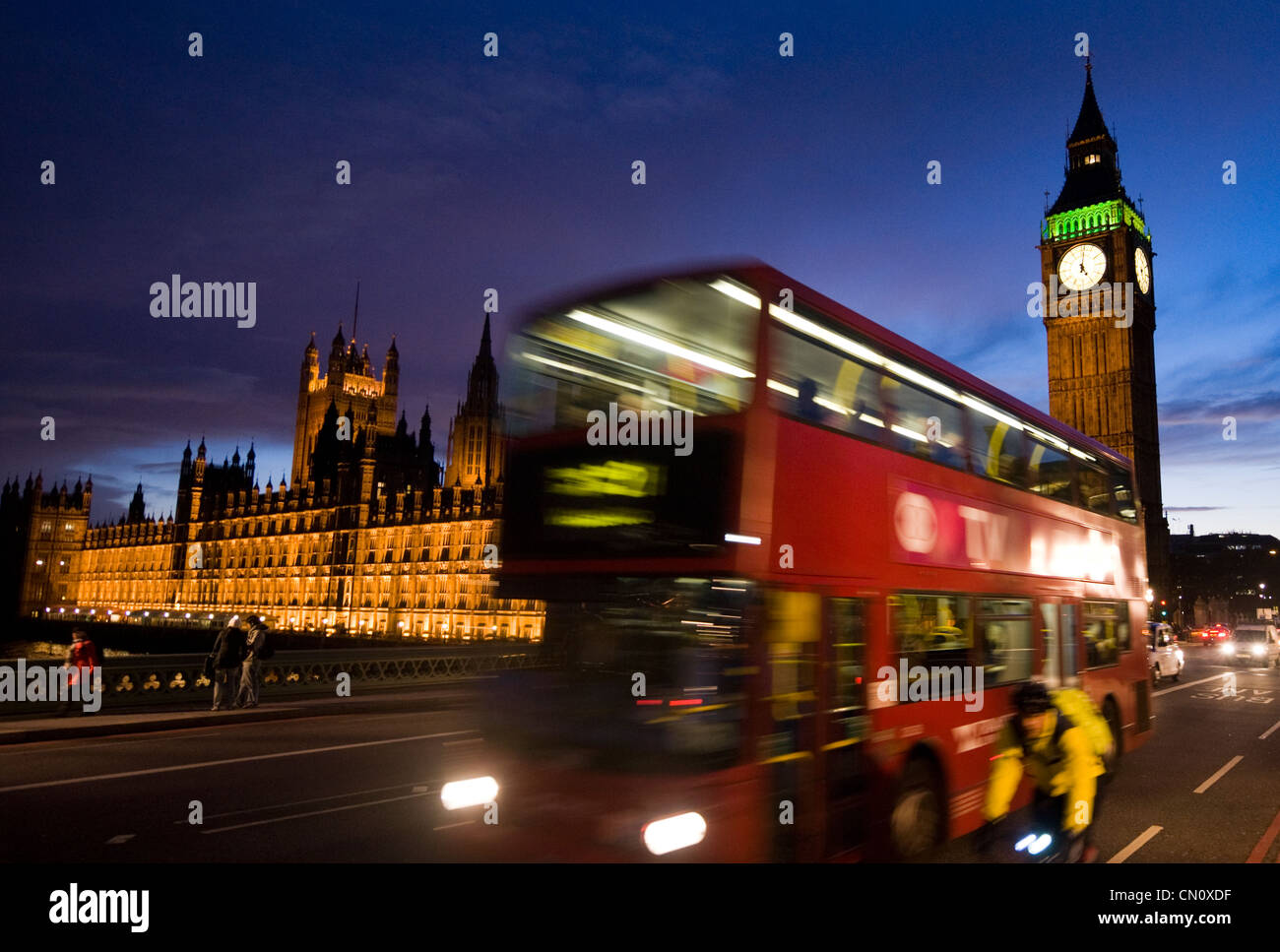 Double Decker bus and cyclist zoom past the Palace of Westminster (Big ...