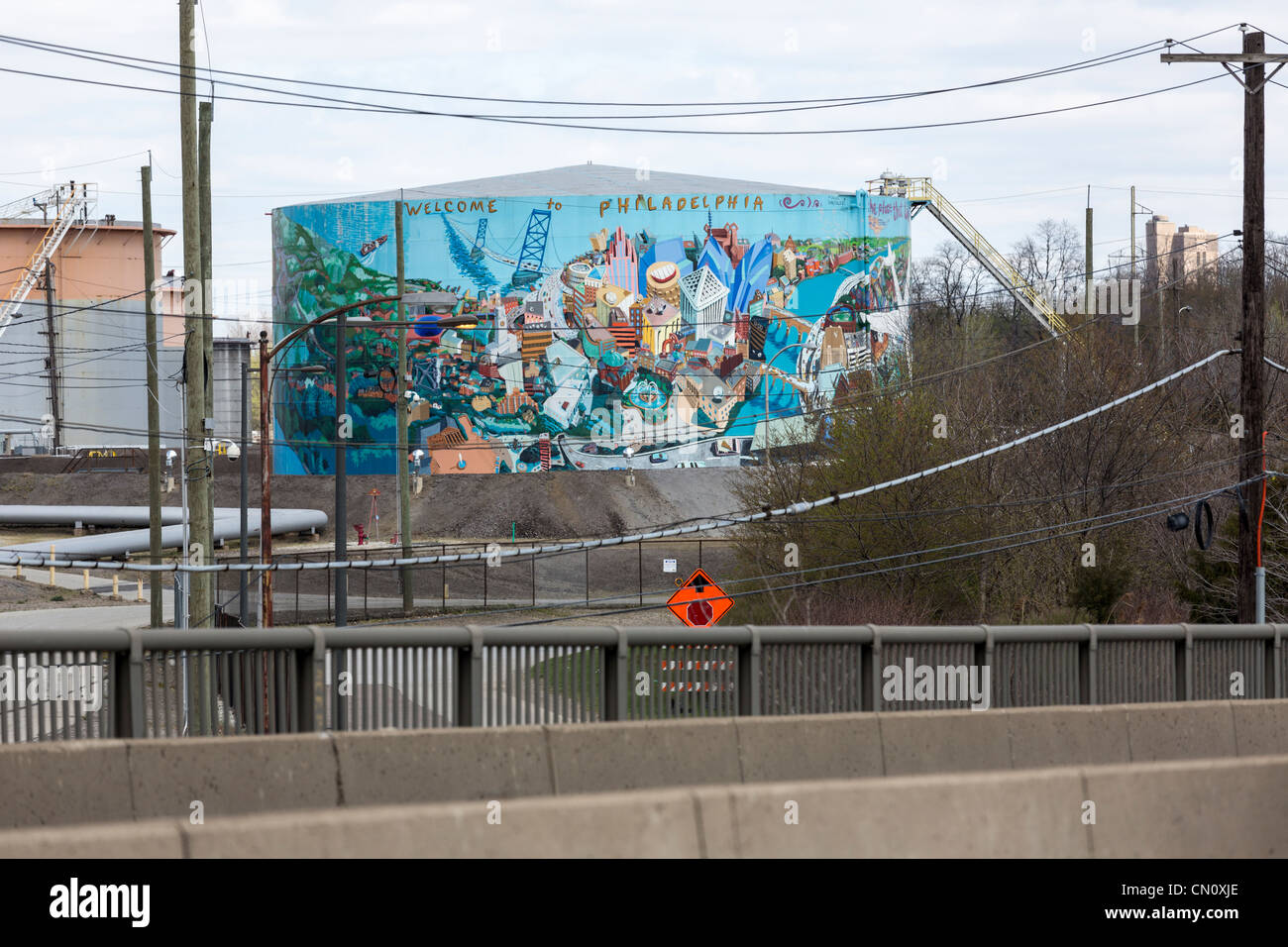 view of tank of Sunoco oil refinery with mural Welcome to Philadelphia ...